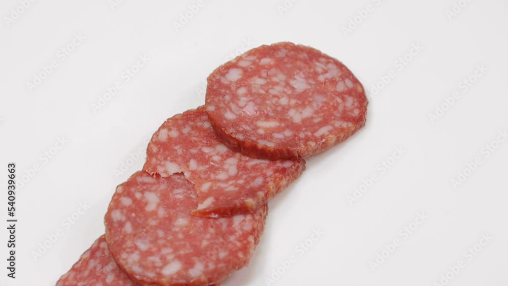 salami sliced into pieces rotates on a white background. Stock Video ...