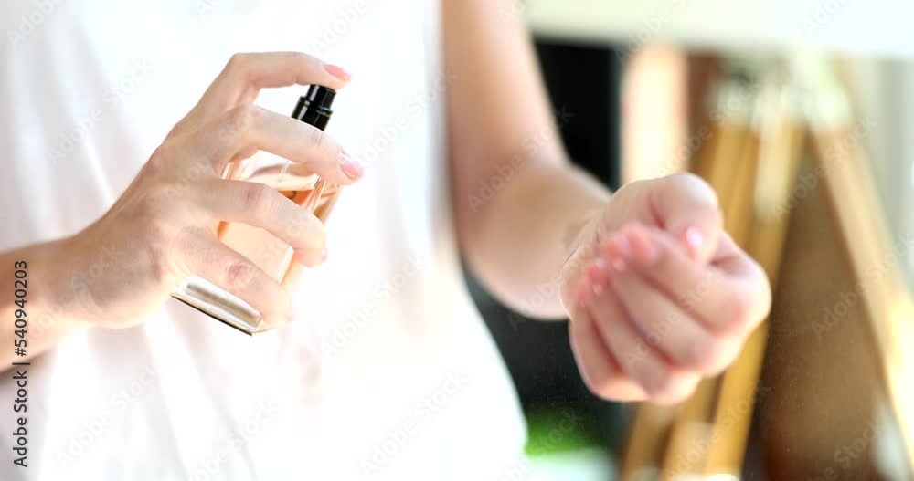 Woman spraying perfume hand wrist at home closeup Stock Video | Adobe Stock
