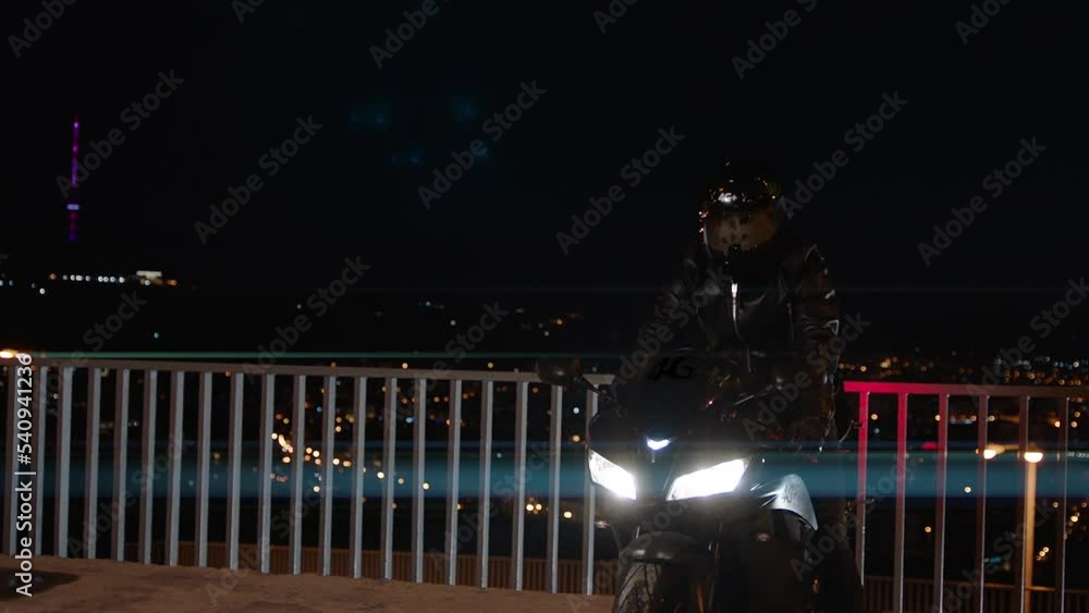 Biker with super sport motorcycle . All in black Motorcyclist starting ...