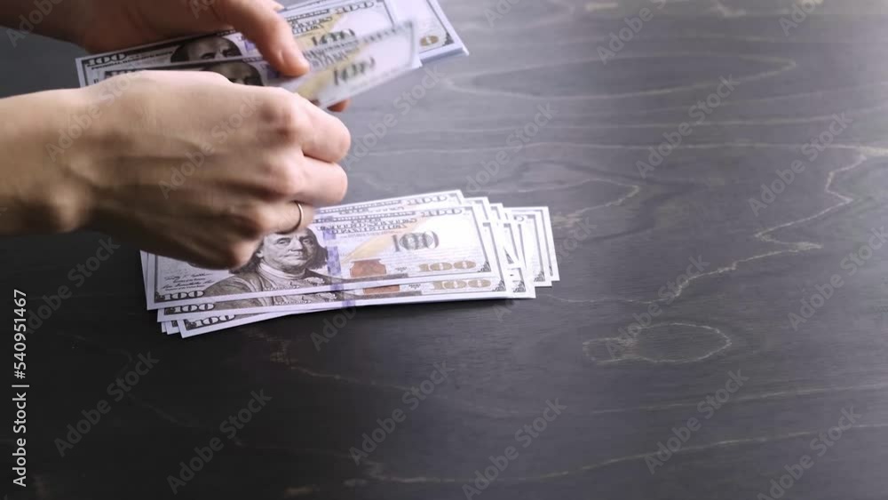 100 USA dollar banknotes bundle. The woman counts the money. Counting ...