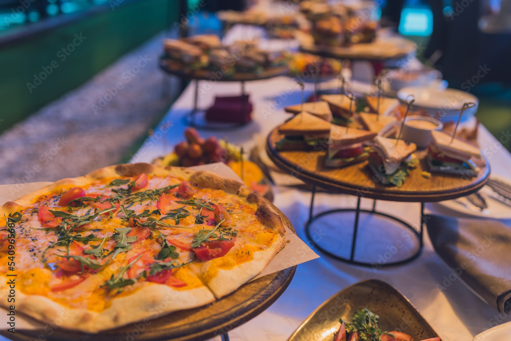 buffet table for a banquet, sandwich and pizza. Stock Photo | Adobe Stock