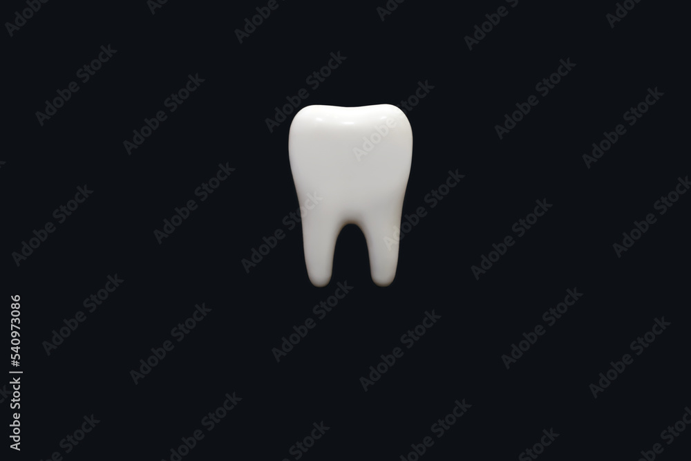 A molar on a black background in the center of the image. Medical ...