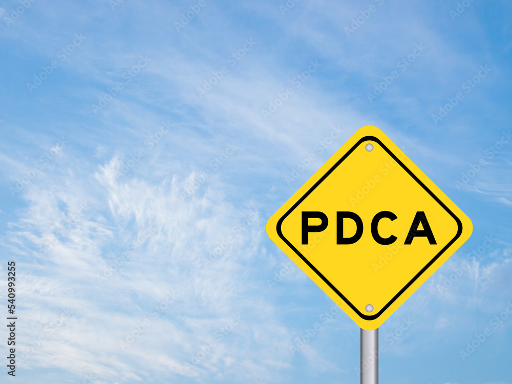 Yellow transportation sign with word PDCA (Abbreviation of plan do ...