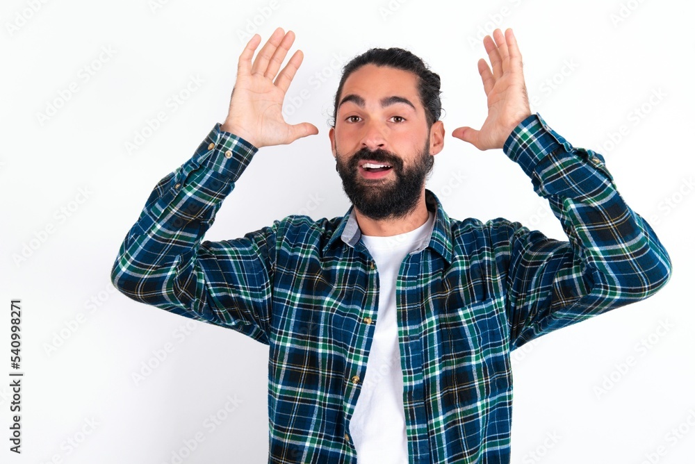 Young Bearded Hispanic Man Wearing Plaid Shirt Over White Background