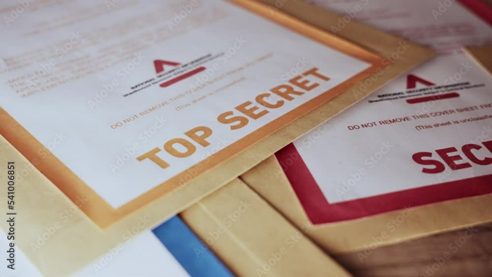 Stack of classified top secret folders and envelops with modern color ...