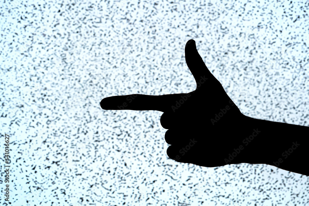 Man doing the finger guns gesture, fingers making a gun symbol, hand ...