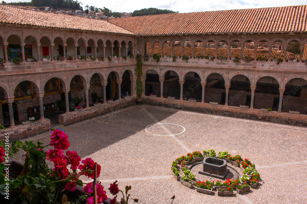 Inner courtyard with arches and columns, decorated with flowers, in ...