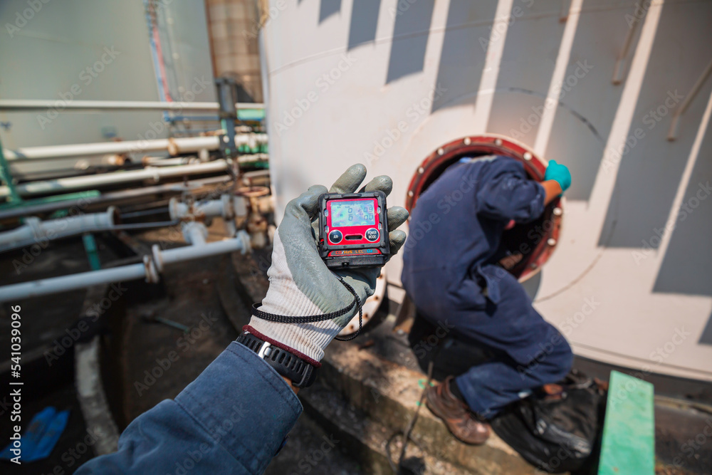 Worker hand holding gas detector inspection safety gas testing at front ...
