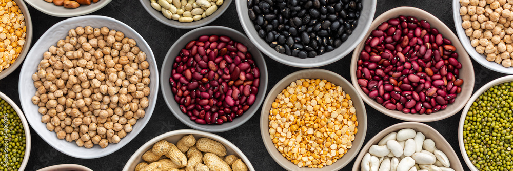 Banner of different types of legumes in bowls, green with yellow peas ...