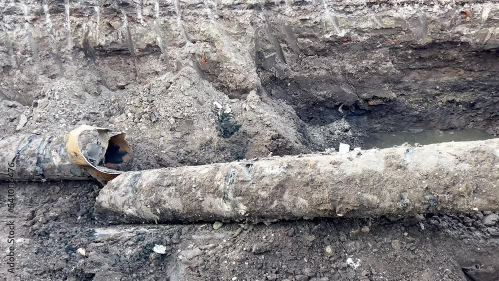 Old cracked concrete sewer pipe. Replacement of old worn sewer pipes ...