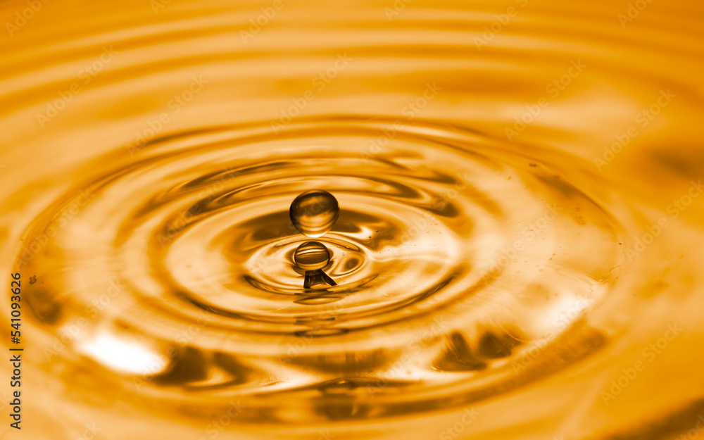 Water droplets flowing on water surface created ripples texture with ...
