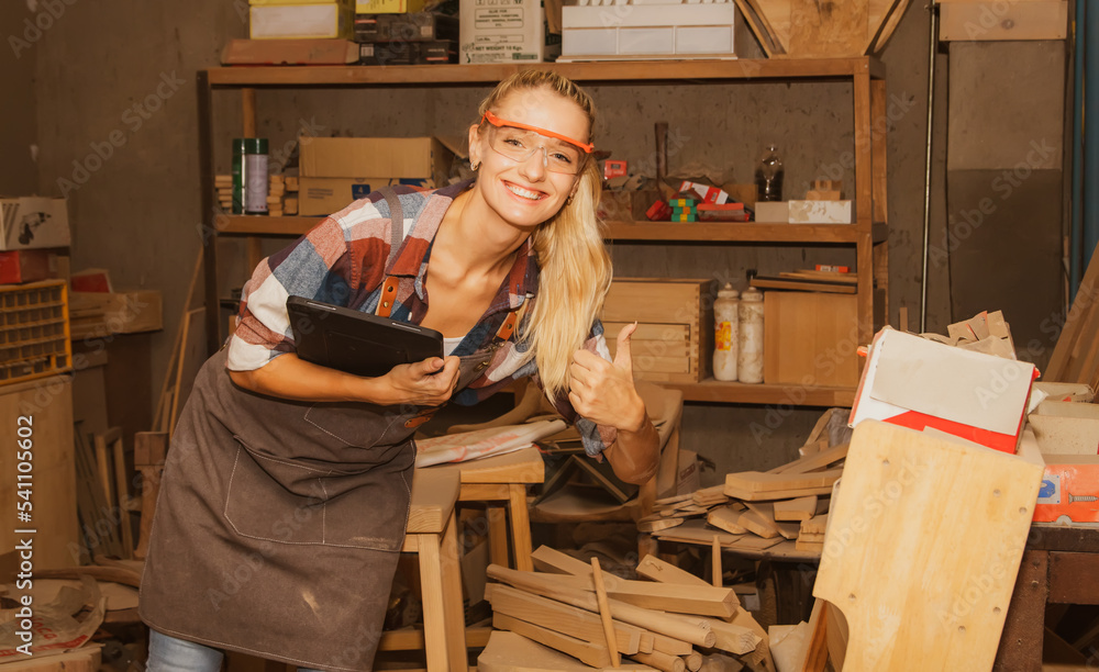Portrait female carpenter worker wearing safety glasses furniture ...