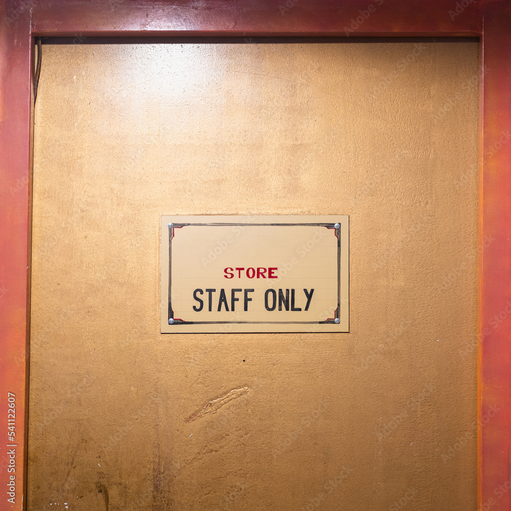 "Staff only" sign board on the wooden door of storage room. Sign and ...
