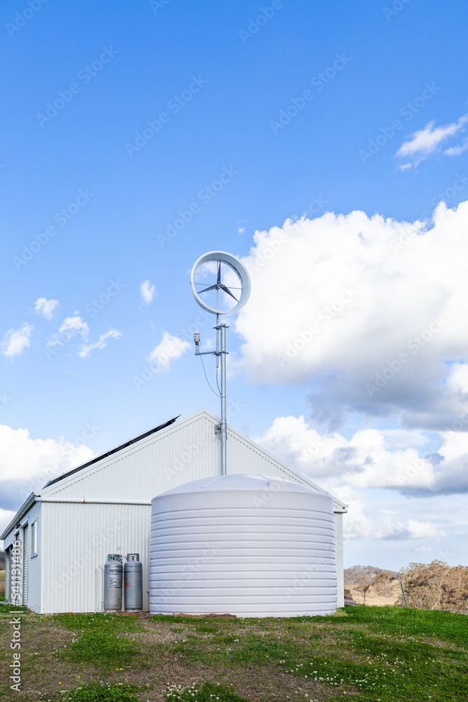 Water tank and shed with mini wind turbine power generator Stock Photo ...