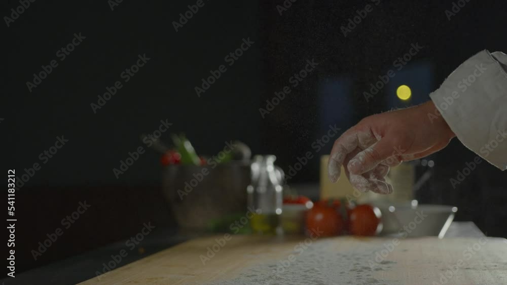 Professional chef throwing flour on chopping. Vegetable used for recipe ...