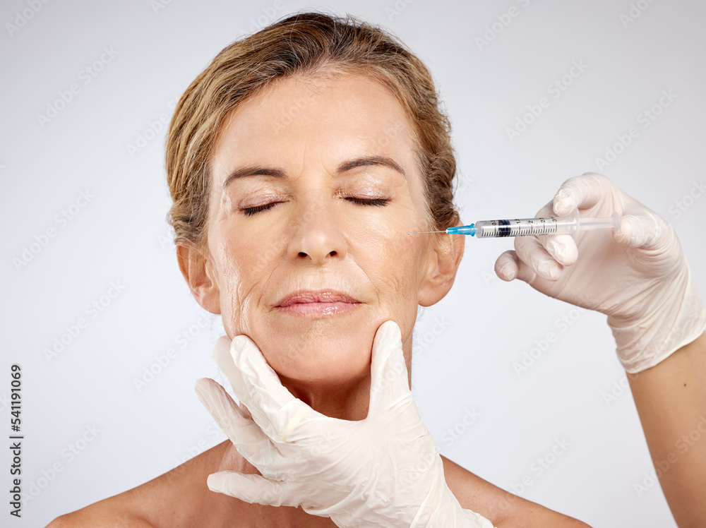 Botox, surgery and face with mature woman getting an injection in her ...