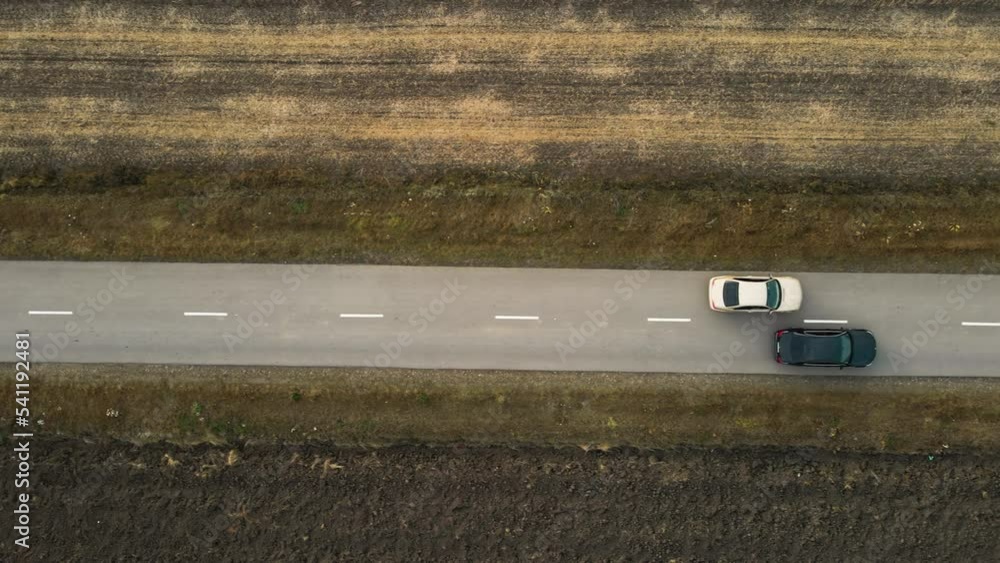 Two cars drive forward on an asphalt road. Speed. Overtaking the car ...