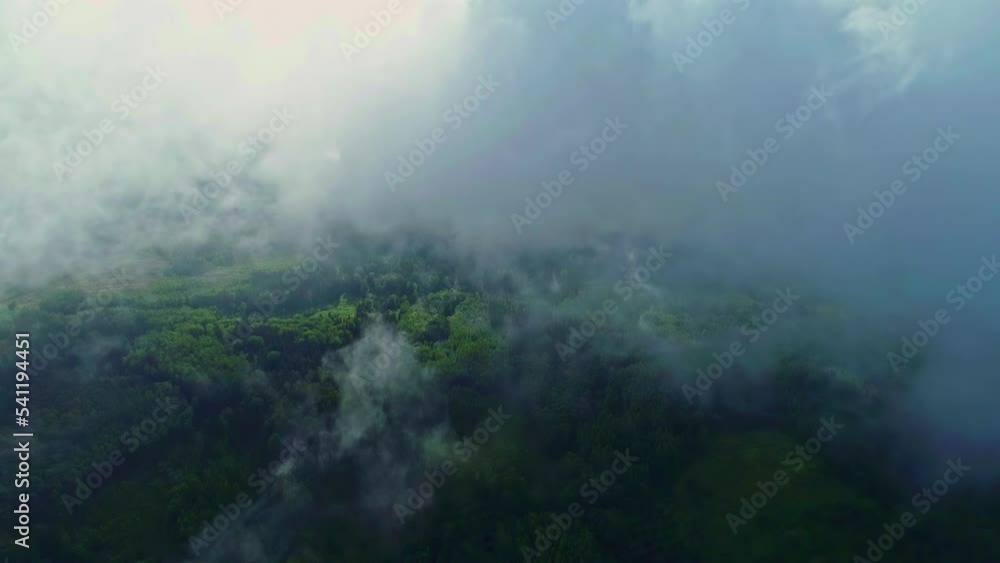 Flying through thick fog and clouds with green landscape below. Stock ...