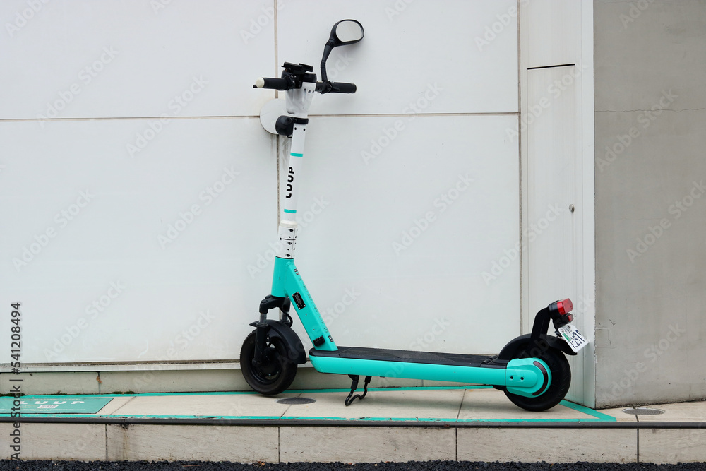 TOKYO, JAPAN - October 25, 2022: A Luup rental e-scooter by a store in ...