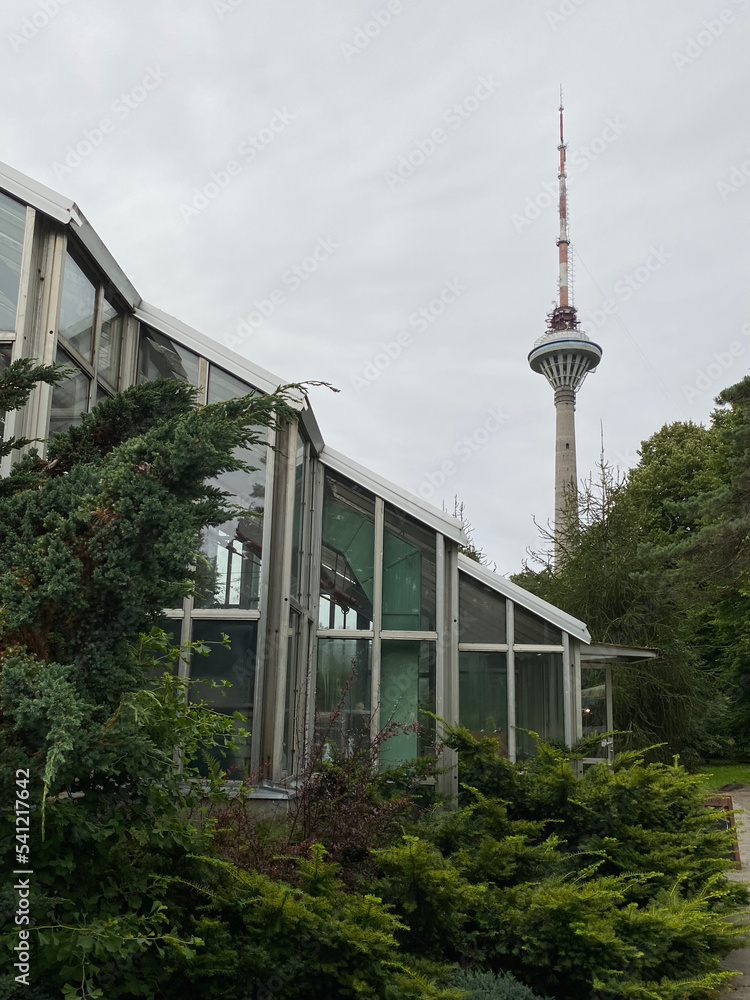 Tallinn TV tower, view from the botanical garden. Old soviet greenhouse ...