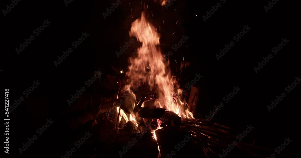 Bonefire, fire flames close-up in campfire. Burning red hot sparks rise ...