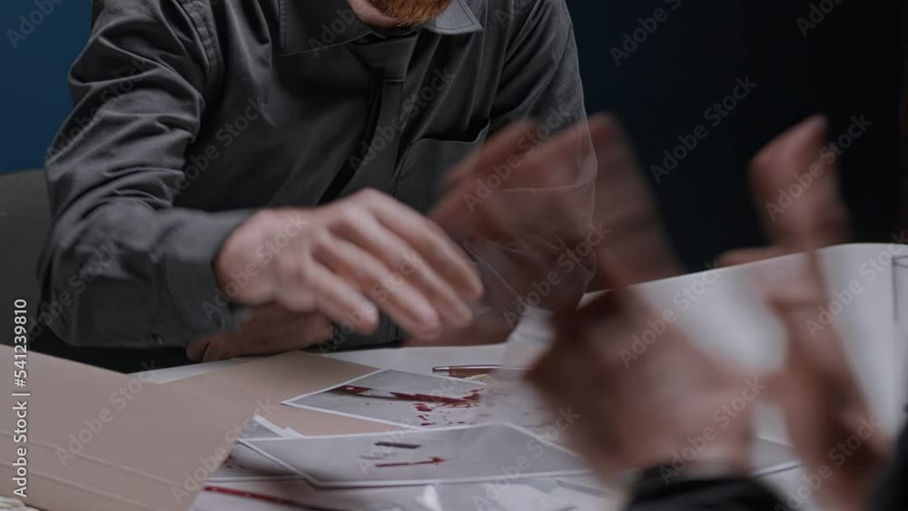 Police officer shows knife in blood in Evidence bag. Detective cop ...