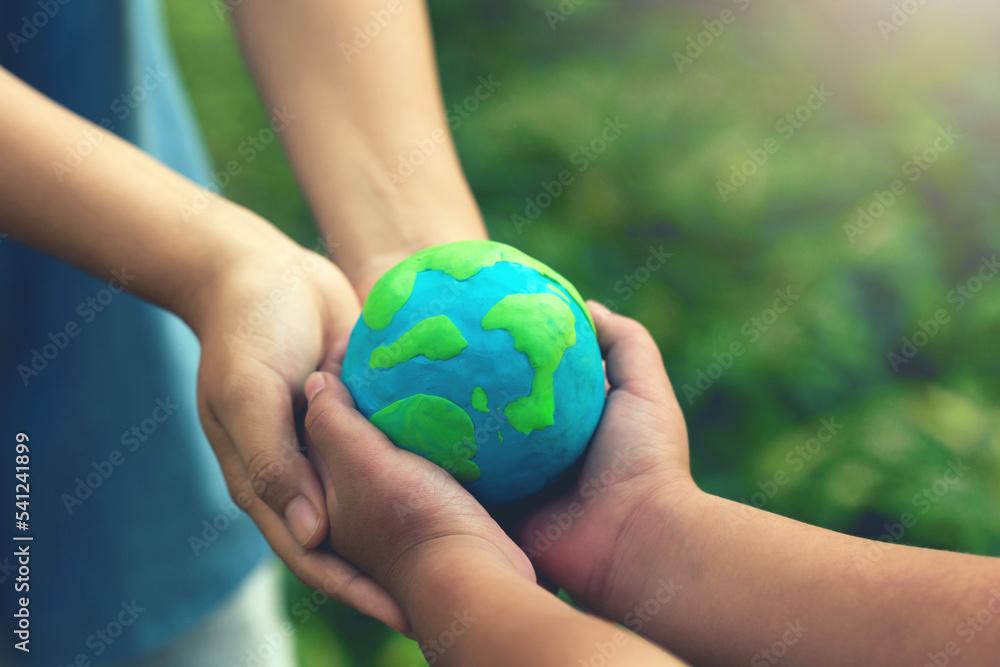 Environment Earth Day. Child and parent hand holding the earth together ...