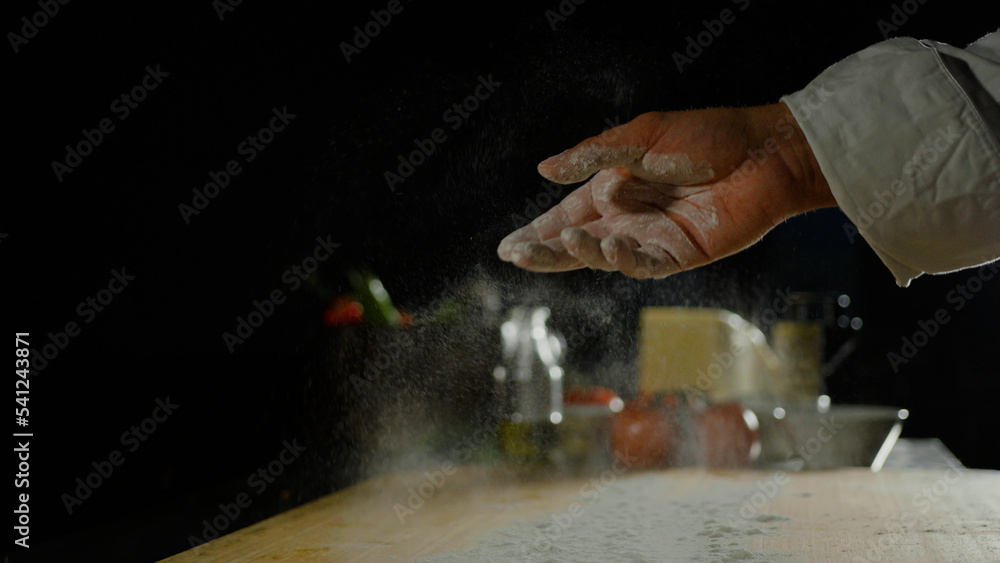 Professional chef throwing flour on chopping. Vegetable used for recipe ...