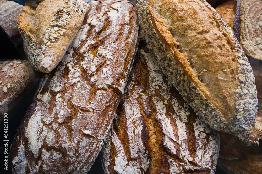 Basket filled with crusty, rustic bread. Close-up shot of a pile of ...