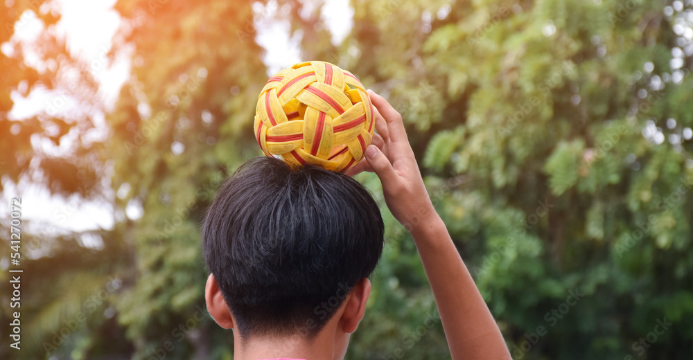 Young southeast asian male sepak takraw player using his right hand to ...