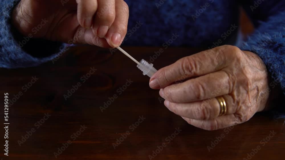 Close-up of old woman taking a self swabbing home tests for Covid19 ...