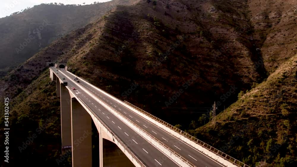 areal footage of traffic on the highway bridge in mountain area Stock ...
