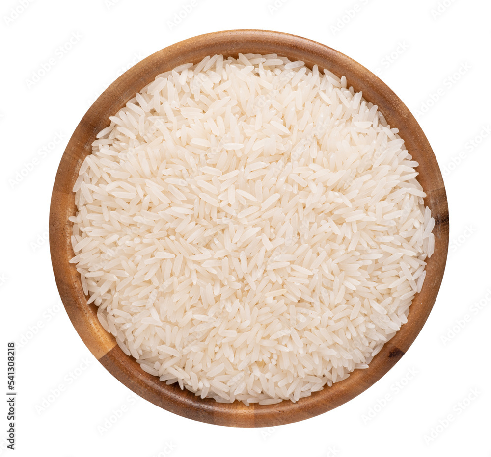Uncooked rice in wooden bowl top view isolated on white background with ...