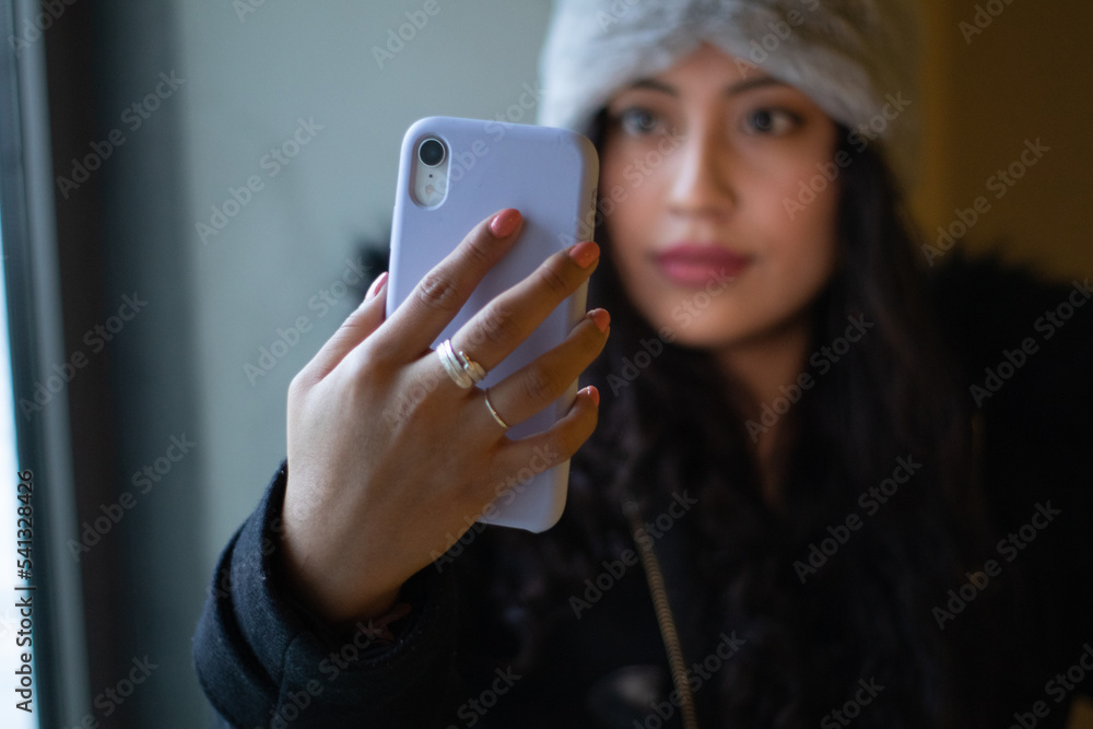 Beautiful Latina Girl Is Shopping In A Mall Taking A Selfie And Wearing A Hair Band Stock