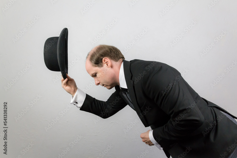 Poster Portrait of Butler in Dark Suit Bowing and Doffing Bowler Hat in ...