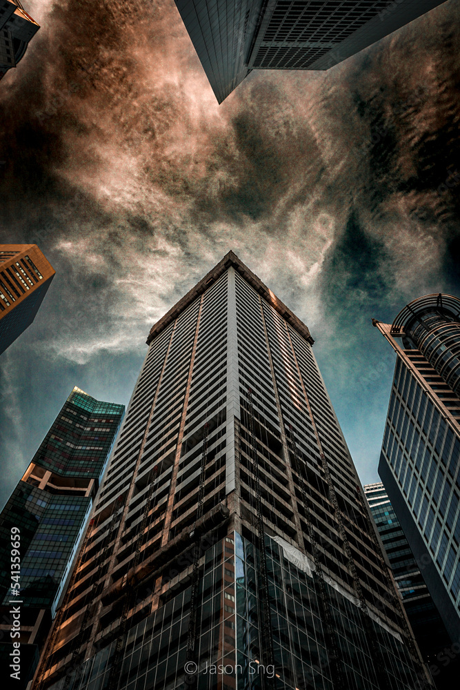 Halve build Sky scrapers looking like collapsing with dramatic sky at ...