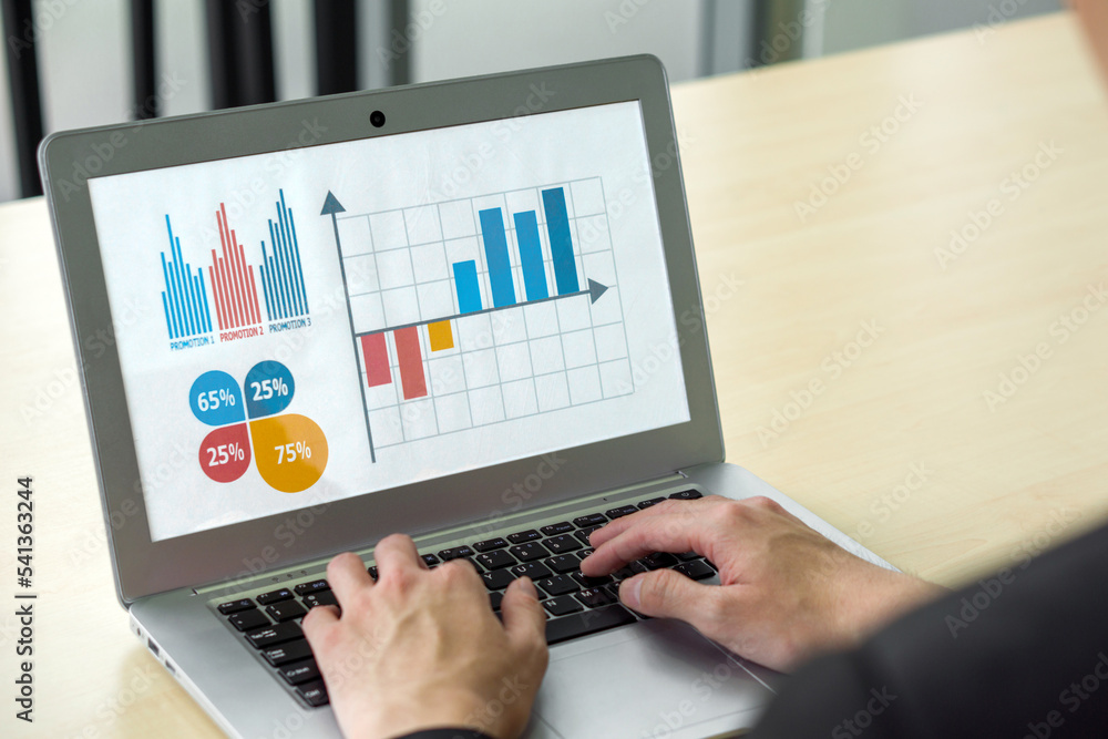 Back view of businessman in suit sit at desk in office typing on laptop ...