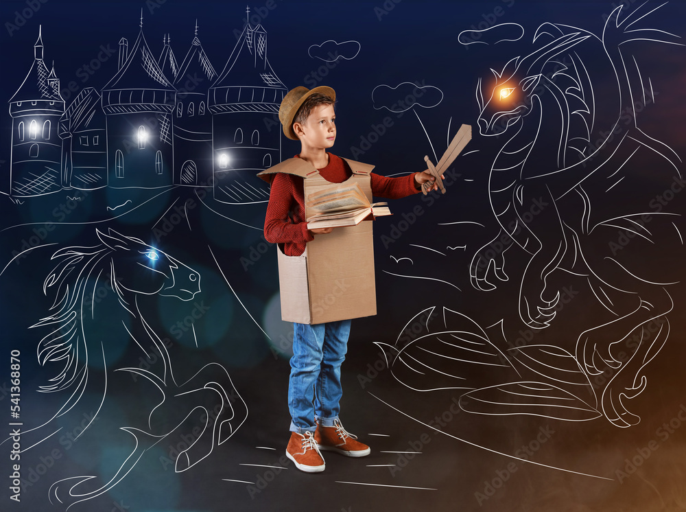 Cute little boy dressed as knight holding book in drawn magic kingdom ...