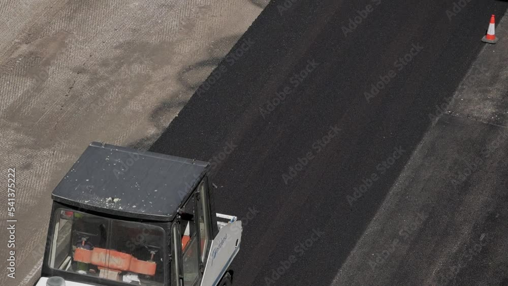 Asphalt compaction with pneumatic road roller vehicle during pavement ...