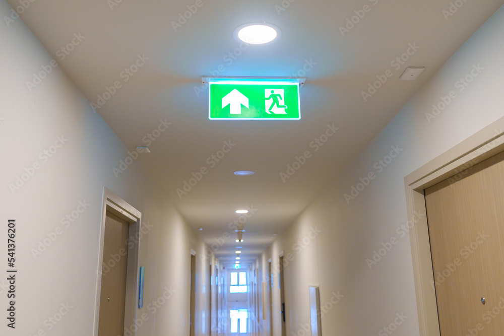 Fire Emergency exit sign on the wall background inside building. Safety ...