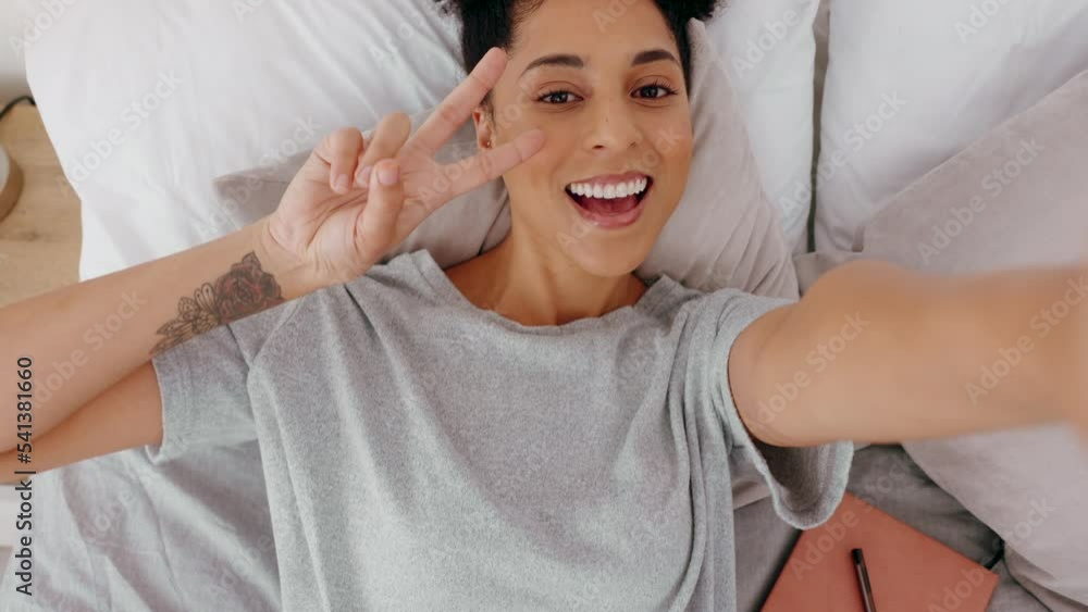 Pov, selfie and woman in bed, happy, wake up and relax in a bedroom, hand and peace sign in her ...