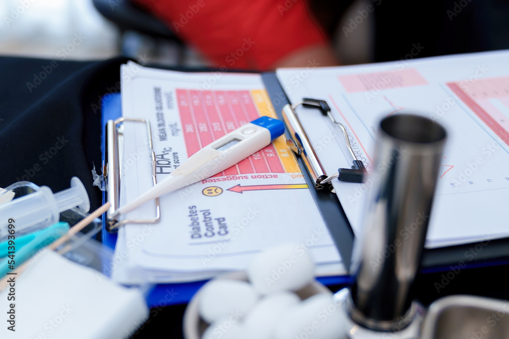 Medical table with medical documents, chart, thermometer, syringe ...