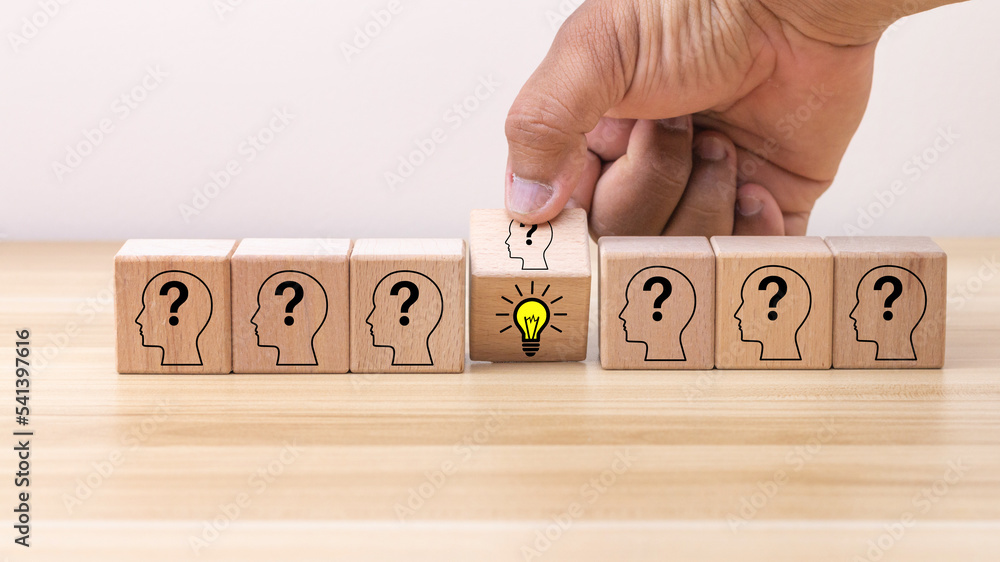 Concept creative idea and innovation. Hand flip over wooden cube block with head human symbol ...