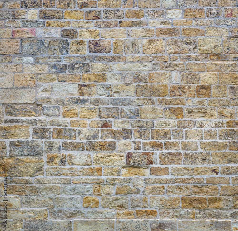 Old masonry wall made of natural stone blocks with a variety of ...
