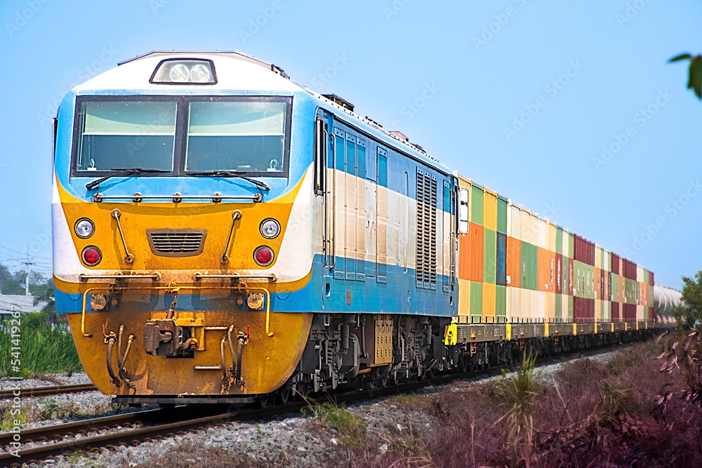 Container-freight train by diesel locomotive on the railway. Stock ...