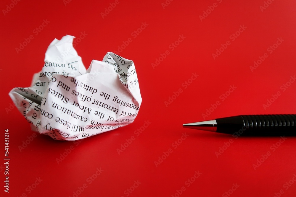 Pen and crumpled paper on red background with copy space. Concept of ...