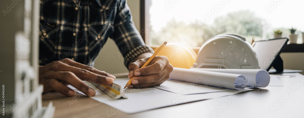 Image of engineer drawing a blue print design building or house, An ...