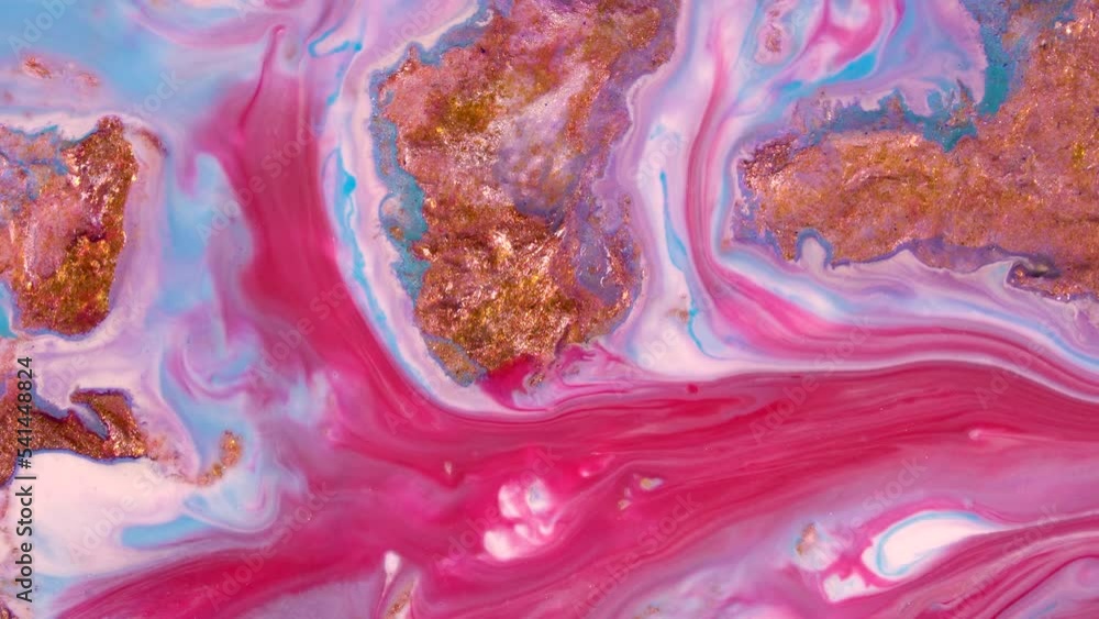 Flowing liquid paints over a golden surface Stock Video | Adobe Stock