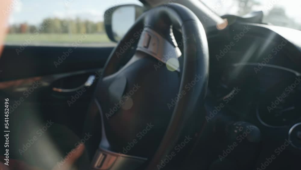 The driver turns the steering wheel of the car. Close-up. Transport ...