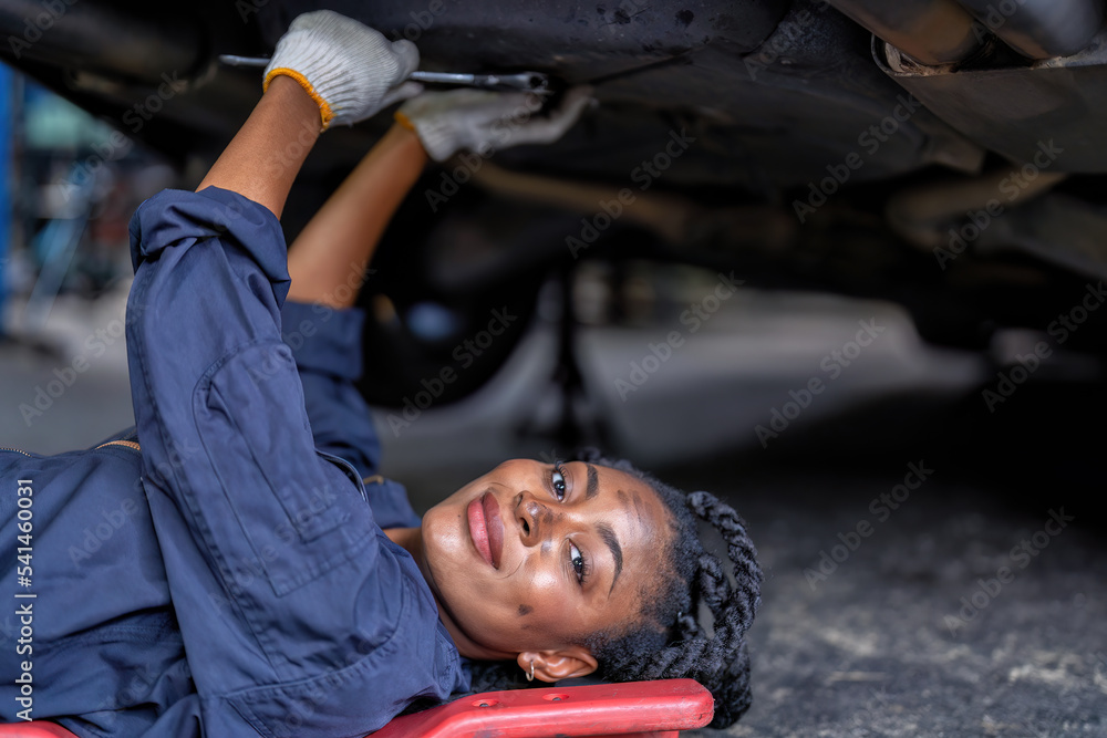 Mechanical girl dirty face wearing overall cover suit lay on garage ...